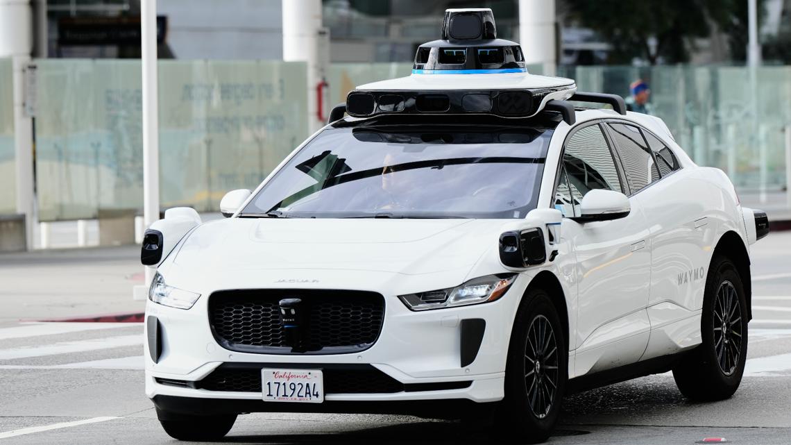 Watch: Driverless Waymo taxi rolls into active LAPD standoff in Los Angeles | kagstv.com